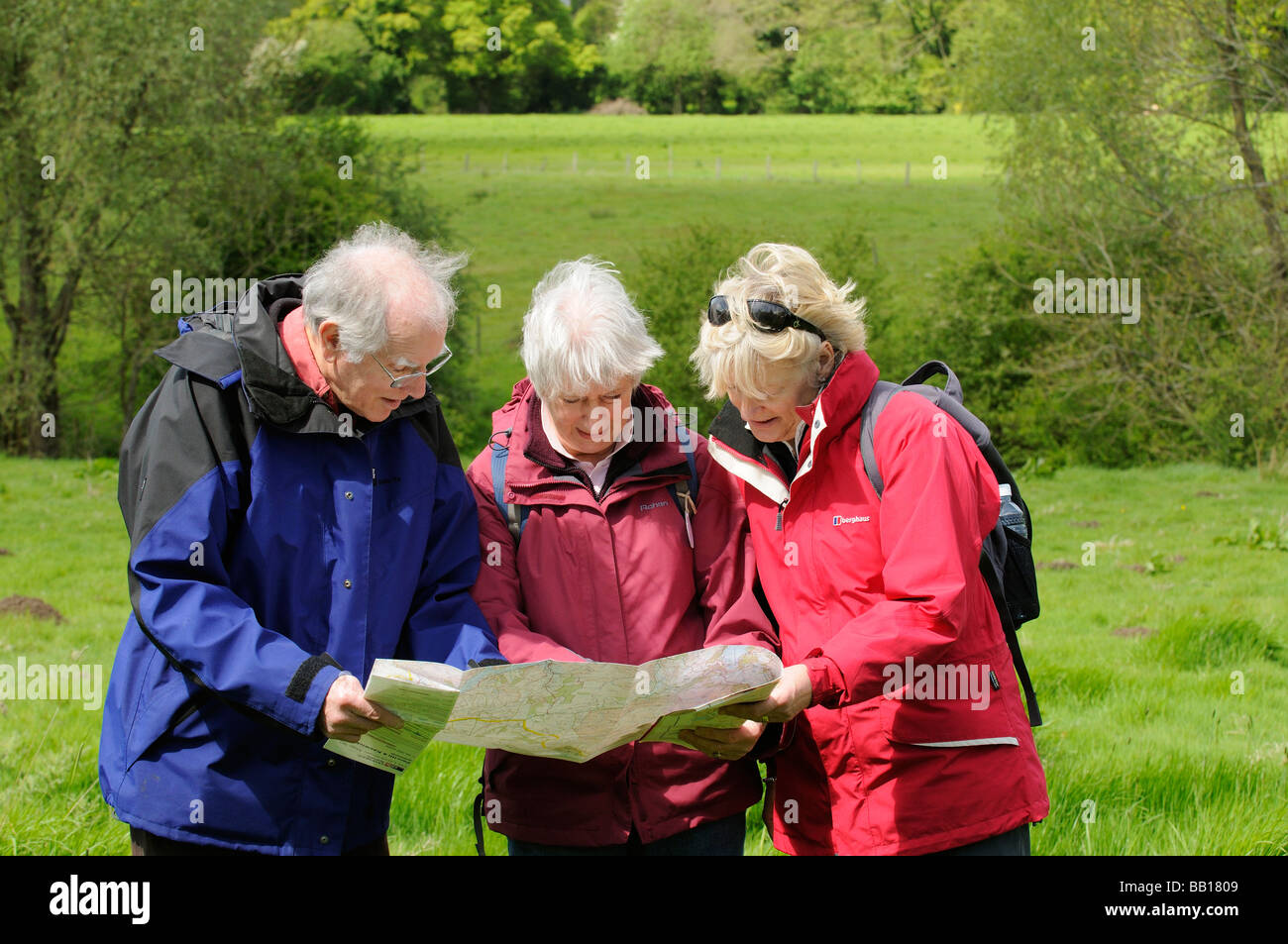 Map reading hikers checking their reference point in the English ...