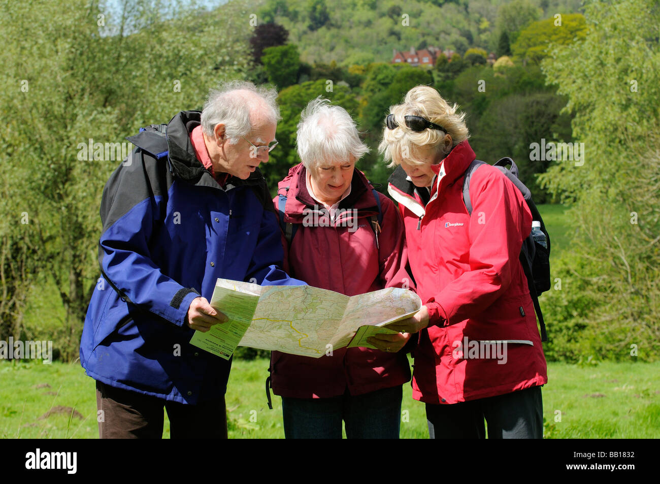 Map reading hikers checking their reference point in the English ...