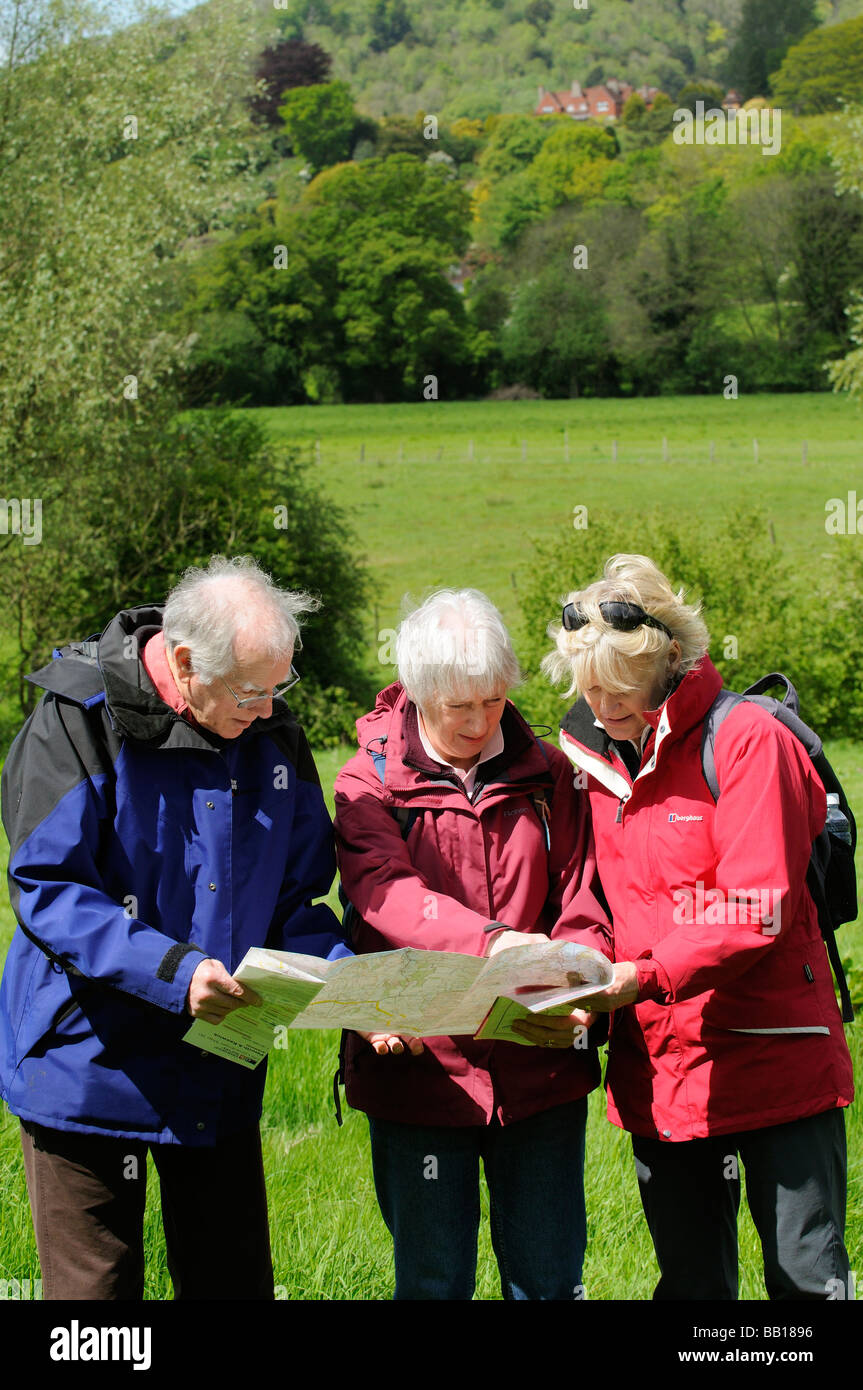 Map reading hikers checking their reference point in the English ...