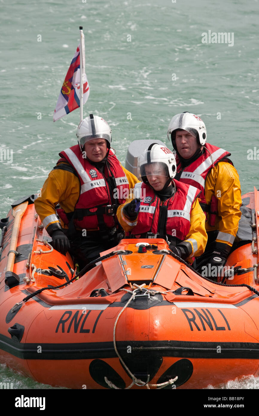 RNLI (Royal National Lifeboat Institution) crew members in a boat ...