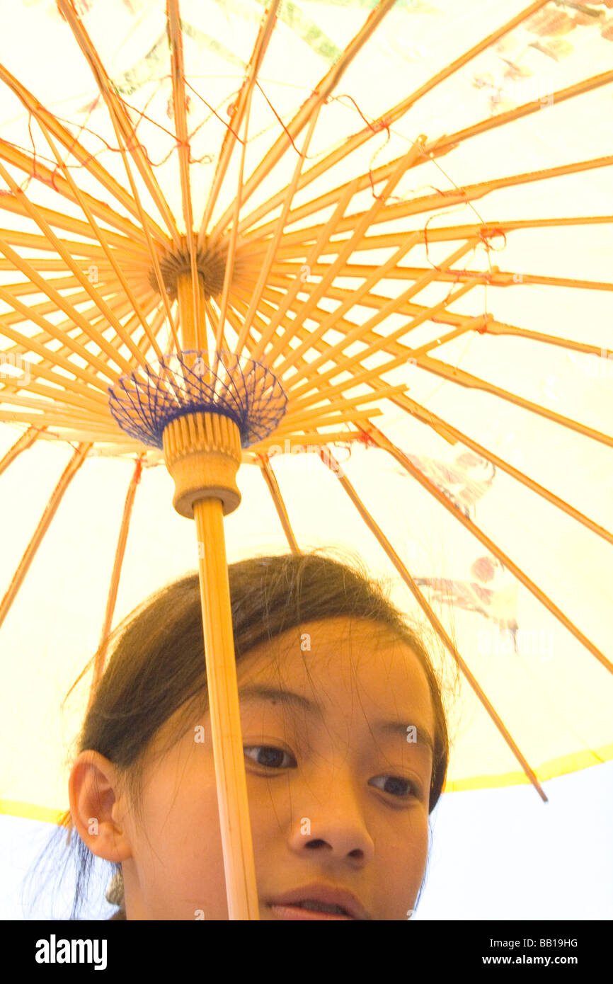 Young Hmong girl under a sun umbrella or parasol. Hmong Sports Festival ...