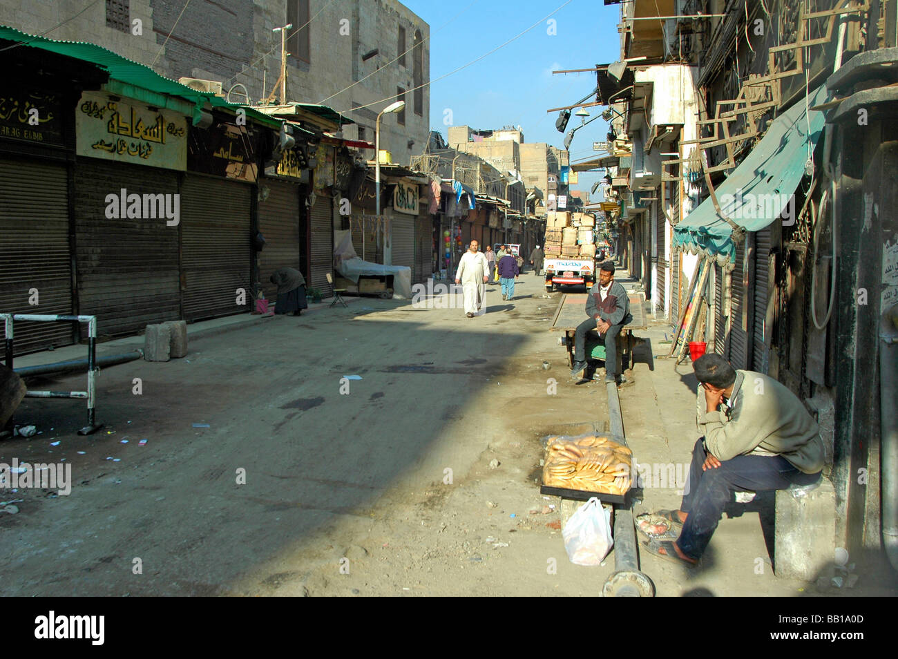 EGYPT, Cairo. Arabic men sitting in a street of a poor district in the ...