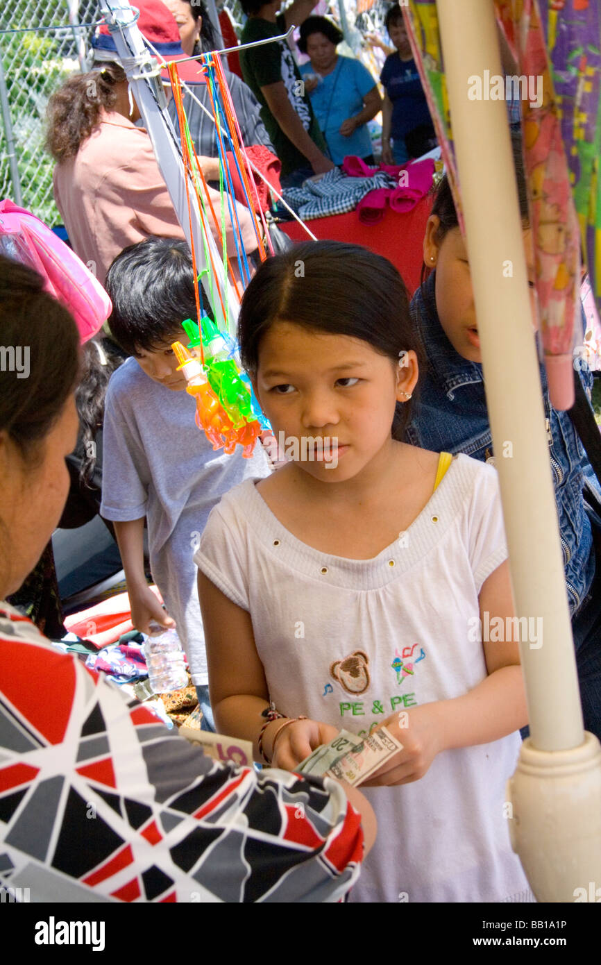 Hmong children buying items from festival vendor. Hmong Sports Festival ...