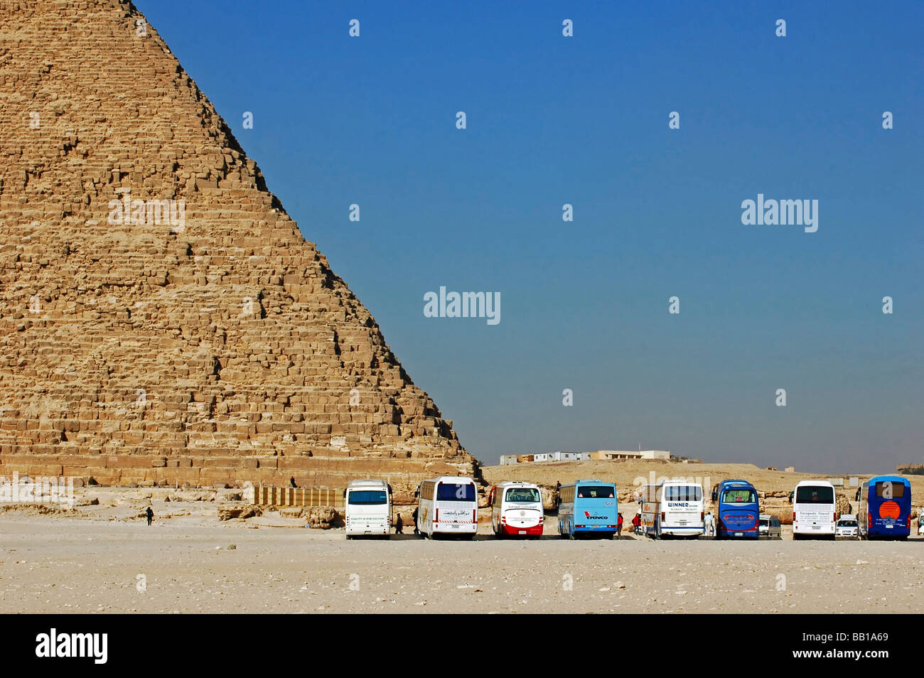 EGYPT, Giza. Big tourist buses parked at the feet of the pyramids in ...