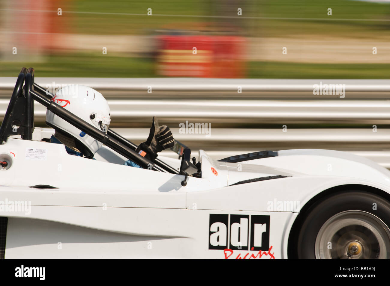 Race Driver Thumbs Up after winning race Stock Photo - Alamy