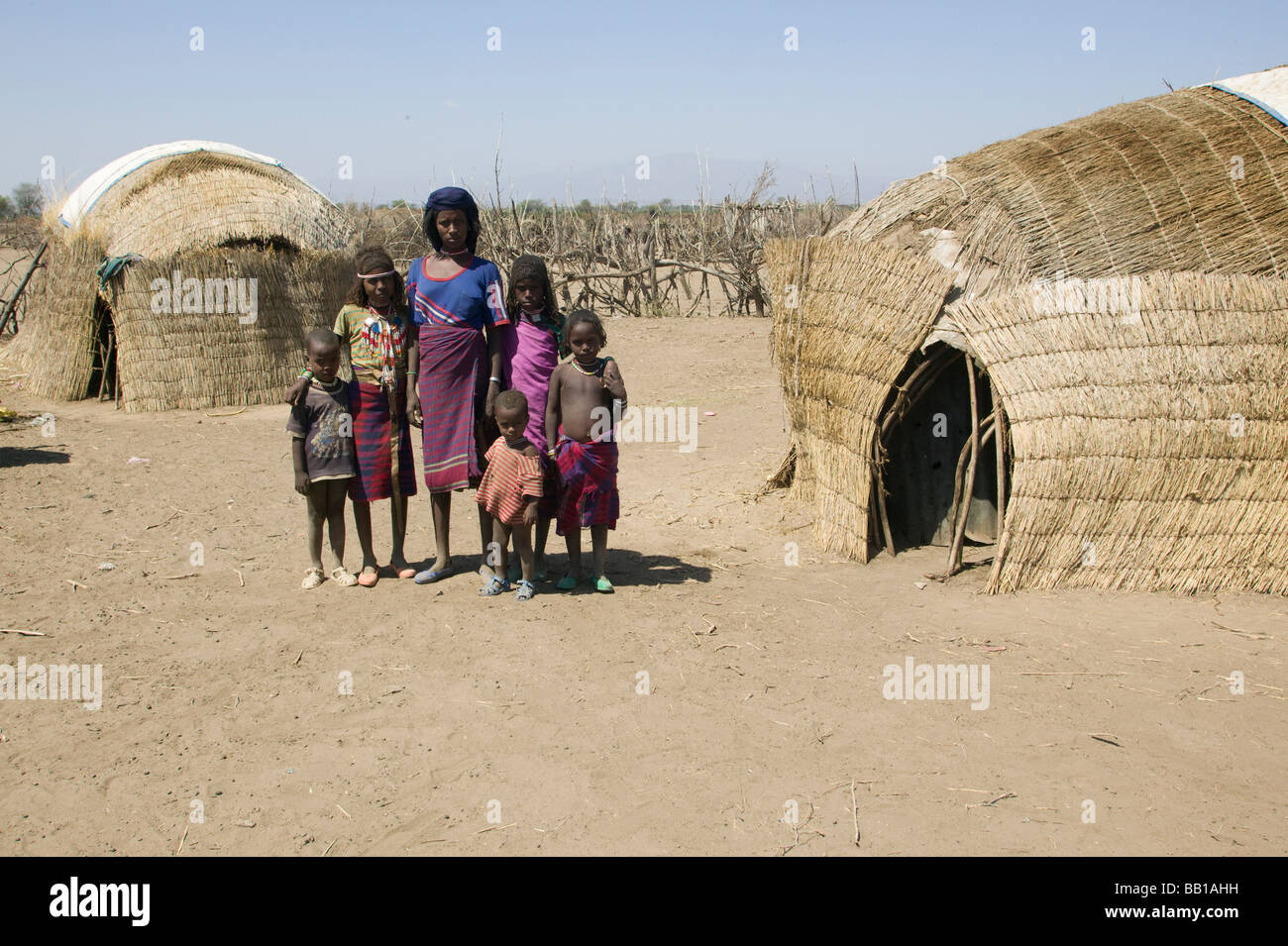 Family standing outside their hut, Afar tribe, Awash Fontale, Ethiopia ...