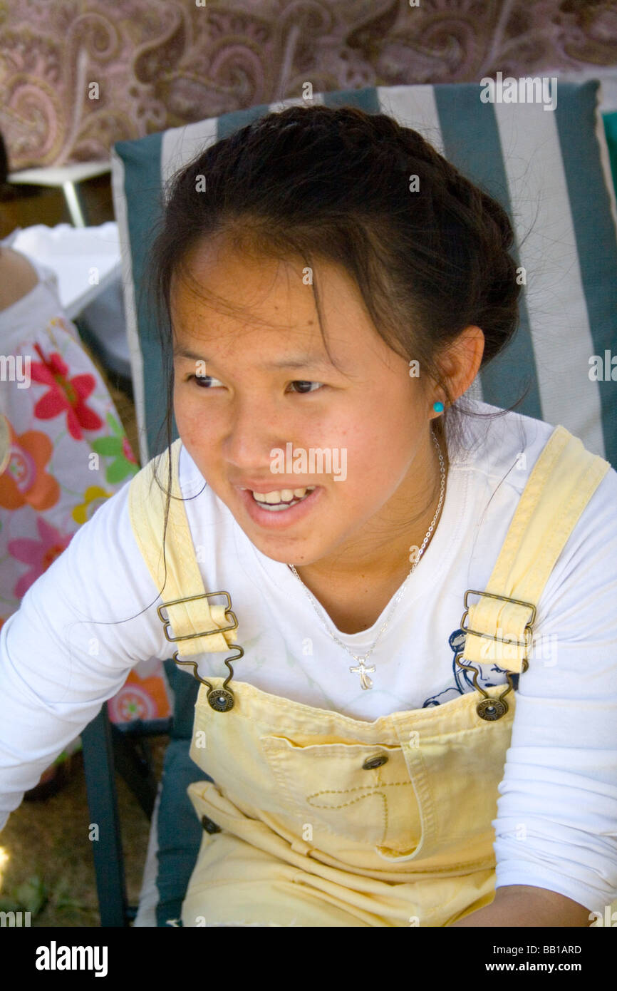 Happy teenage festival worker wearing yellow bibs. Hmong Sports ...