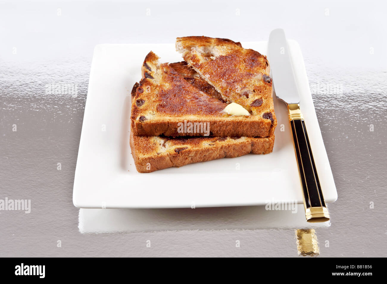 Raisin toast cut with knife on a plate Stock Photo - Alamy