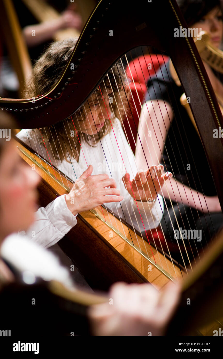 Woman playing a harp hi-res stock photography and images - Alamy