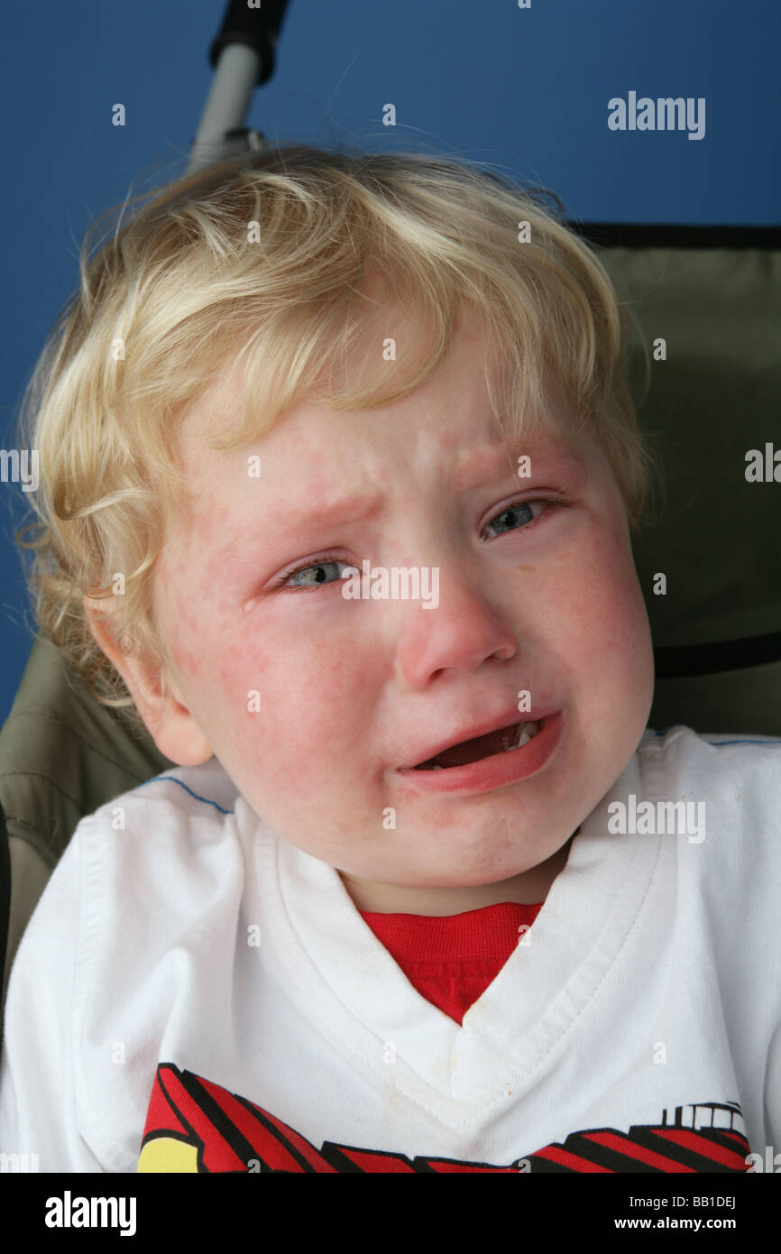 Blonde haired child crying with tears in his eyes Stock Photo - Alamy