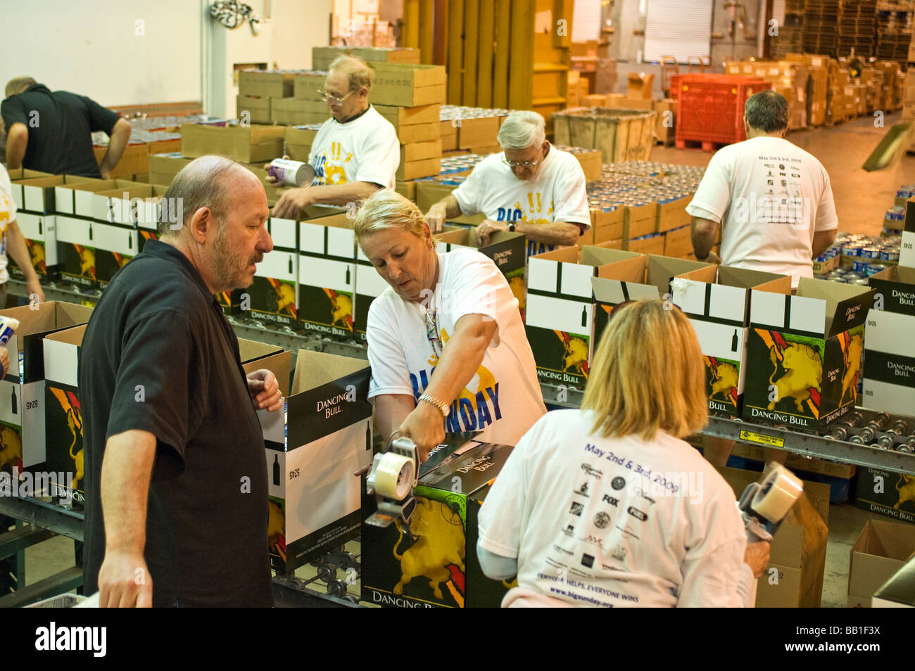 A group of volunteers in the warehouse of the California Food Bank in ...