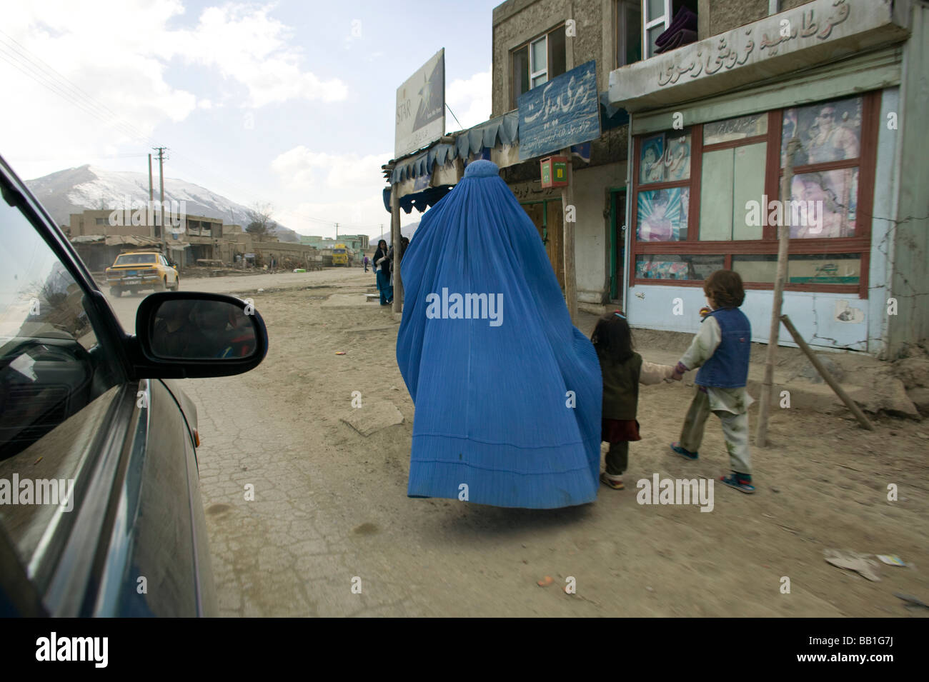 Woman in a burqa walking with her children, Kabul, Afghanistan Stock ...