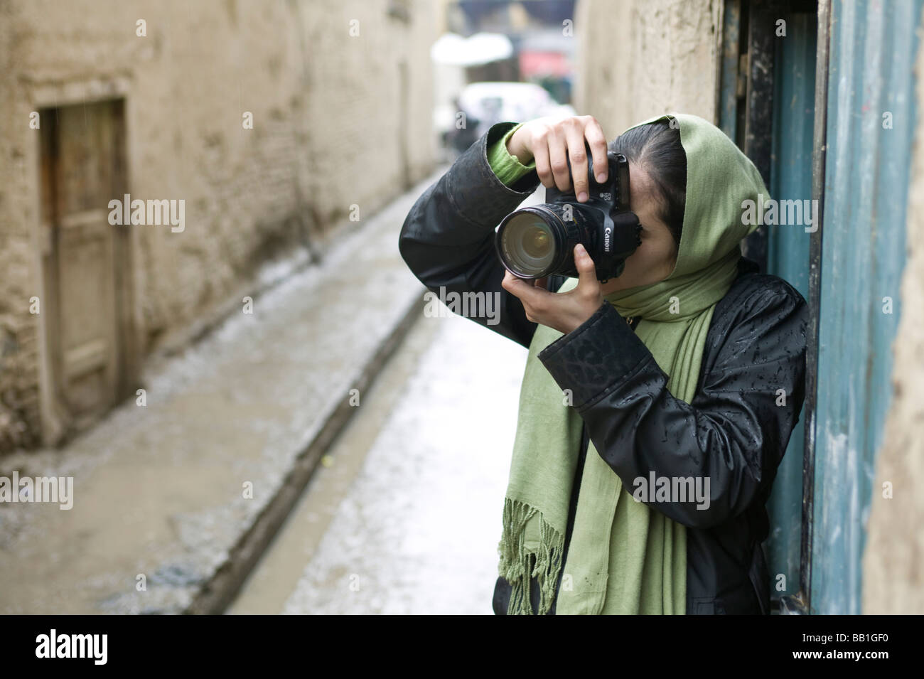 Young photojournalist taking pictures, one of few female ...