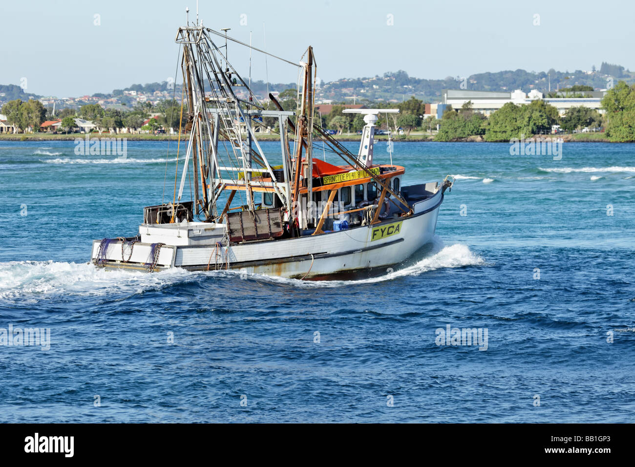 Fishing Trawler navigating a waterway Stock Photo - Alamy