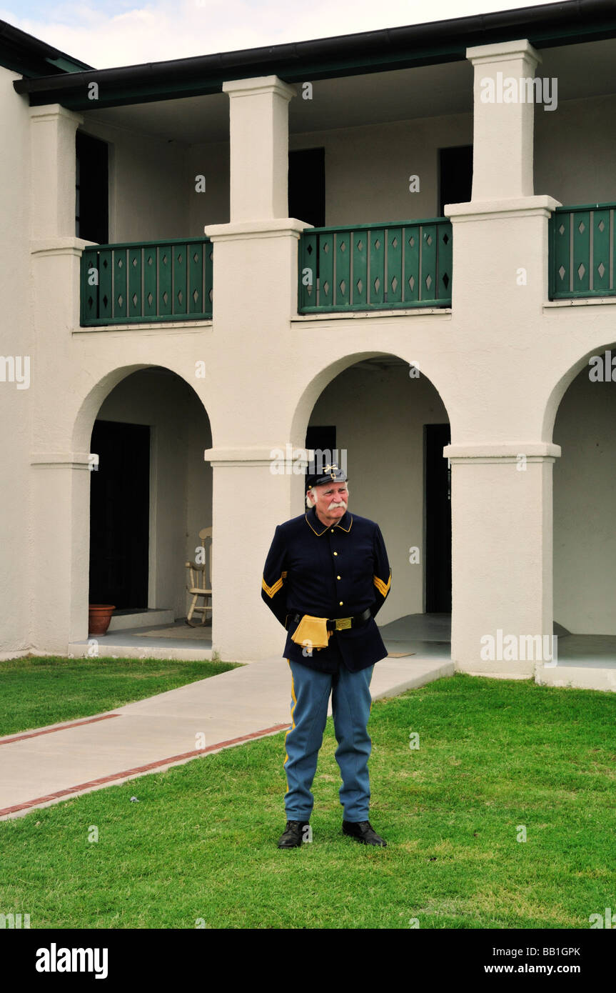 A guide dressed as a soldier stands in front of the Fort Reno visitor ...
