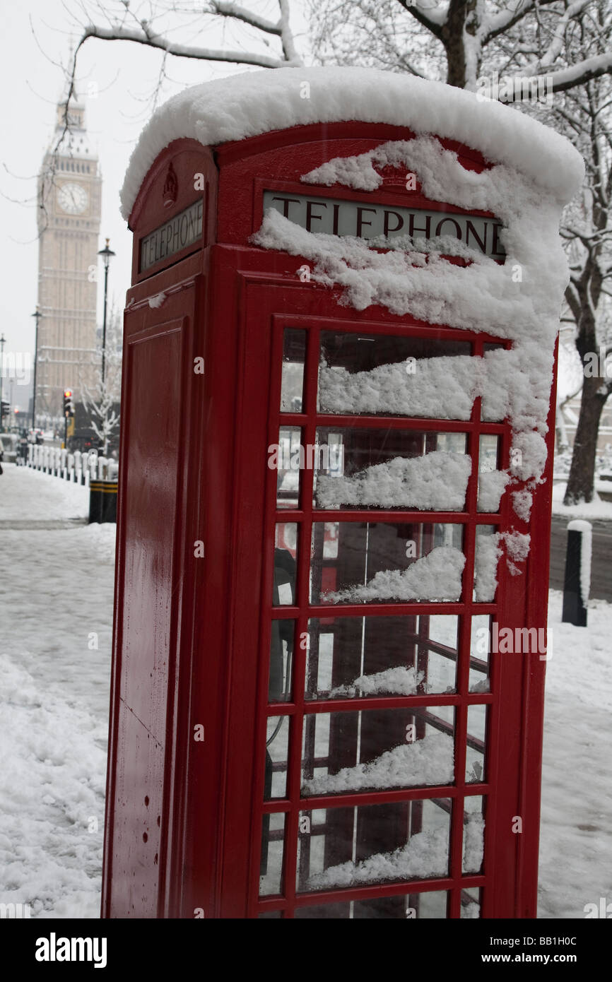 Red telephone box covered in snow Stock Photo - Alamy