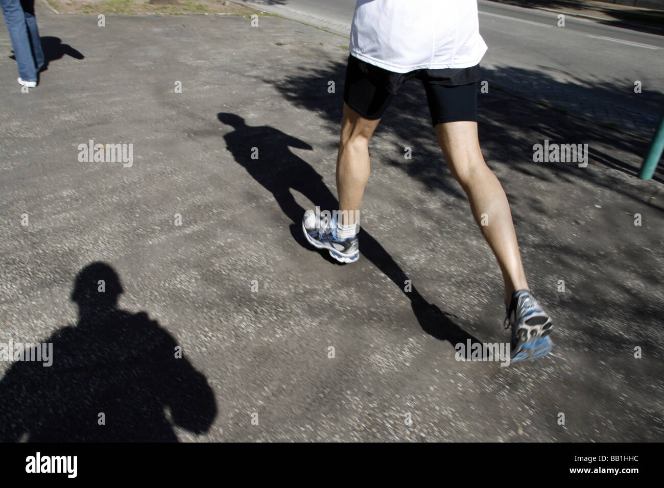 one fast runner in street in sun Stock Photo - Alamy