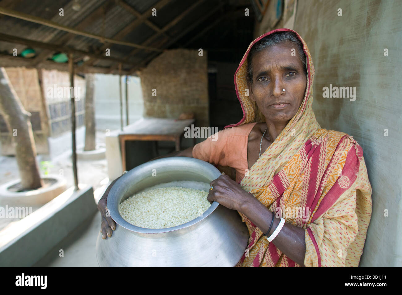 Woman with rice, rural Bangladesh Stock Photo - Alamy