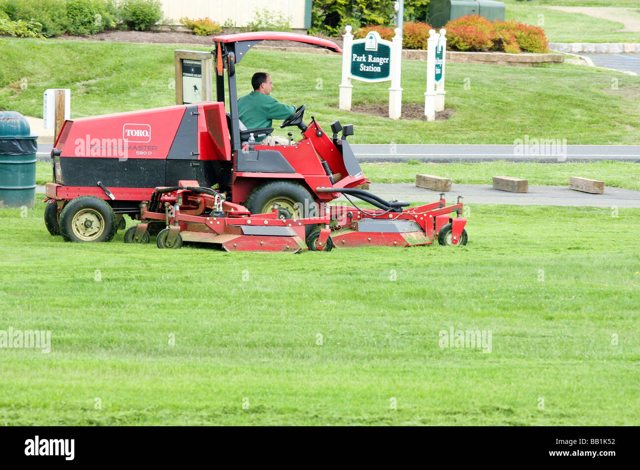 A grounds keeper mowing with a large toro mower Stock Photo - Alamy