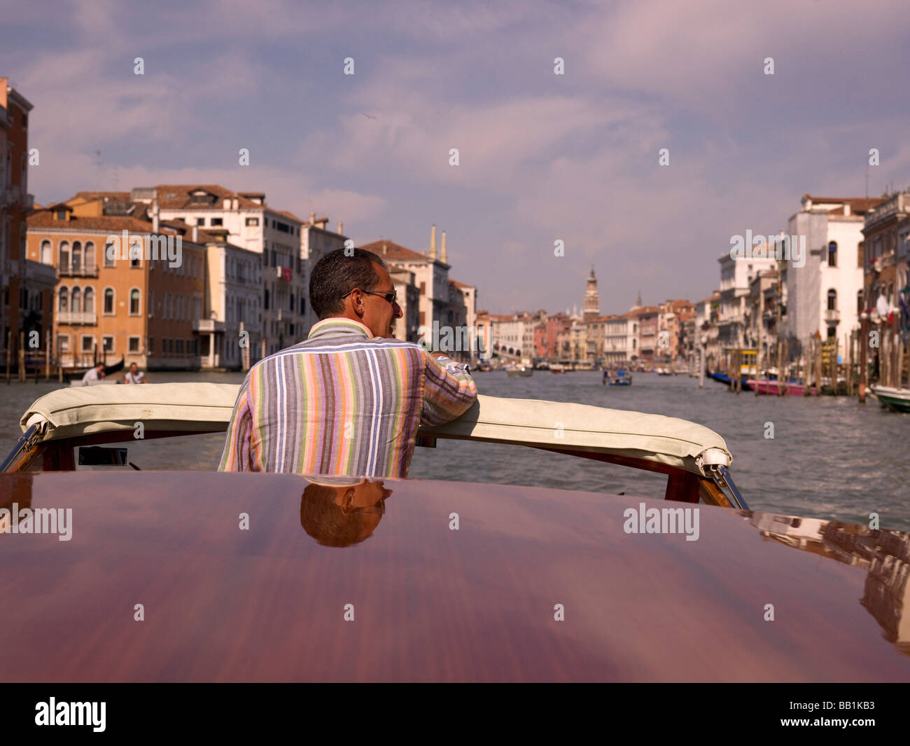 Man standing in motorboat; Venice, Italy Stock Photo - Alamy