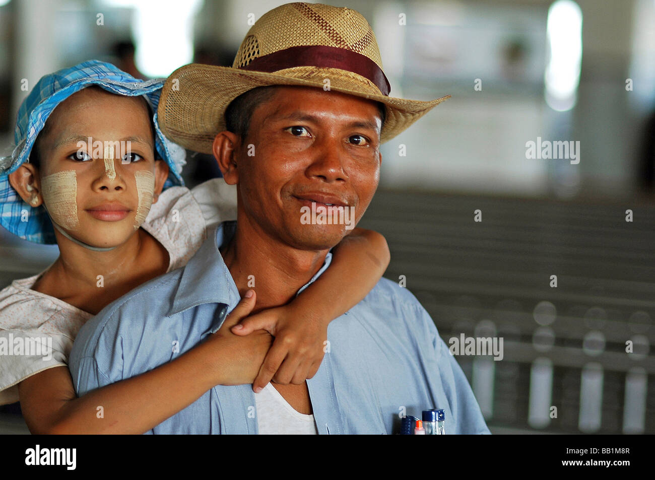 MYANMAR, Mandalay. Father carrying his seven-year-old daughter on his ...