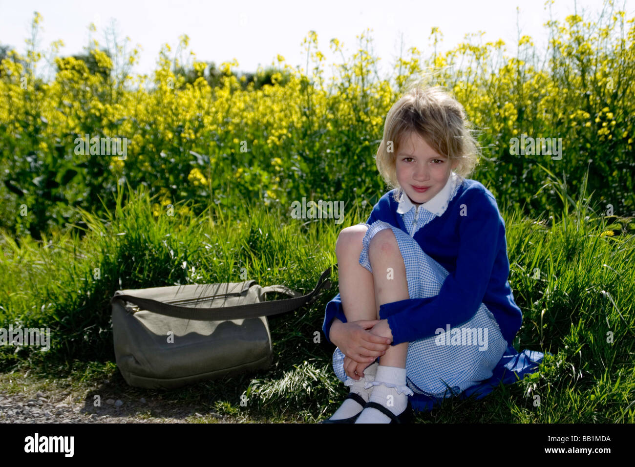 young girl sitting in a field Stock Photo - Alamy