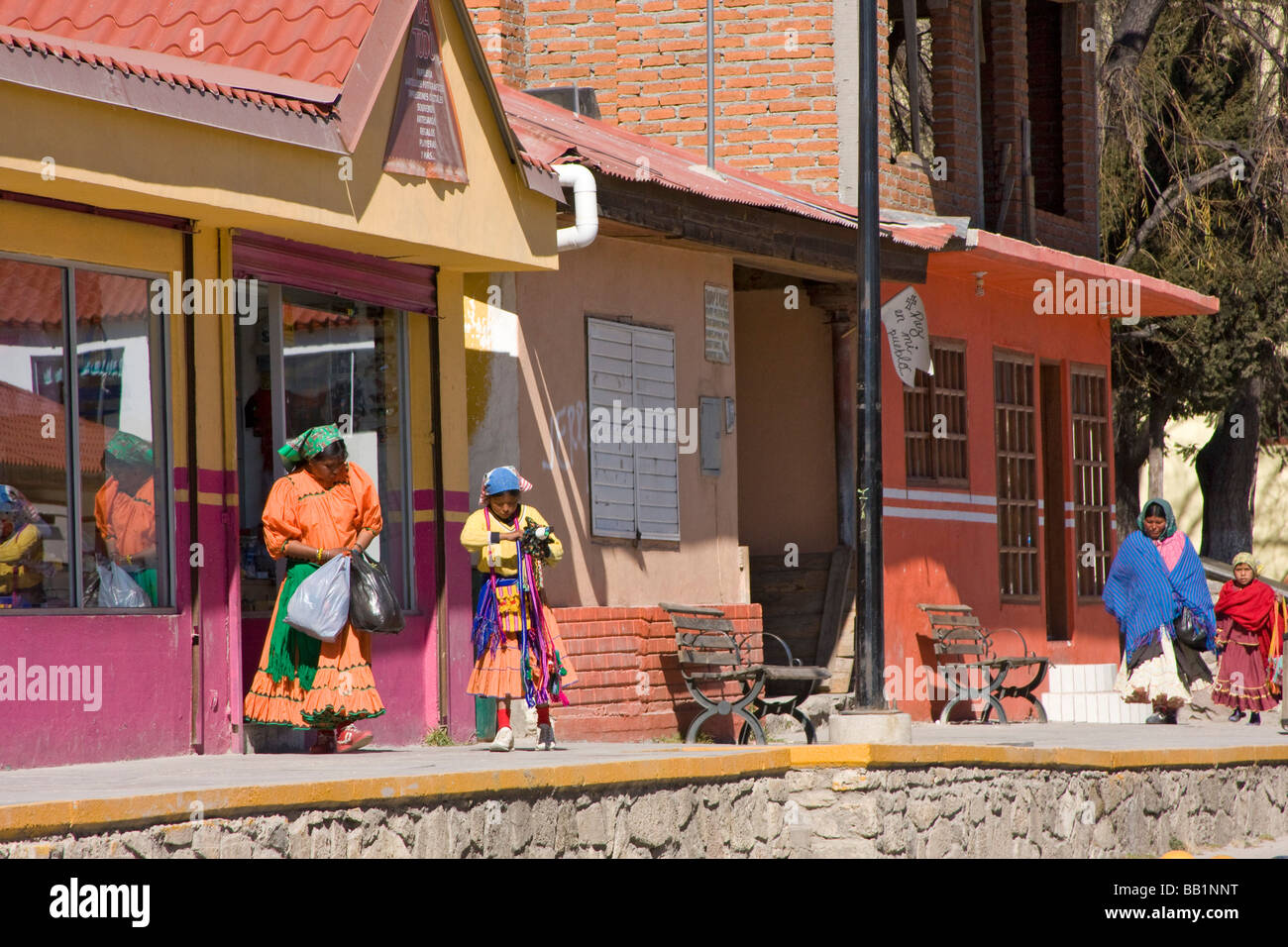 Tarahumara native Indian women walk the main street in Creel, a town in ...