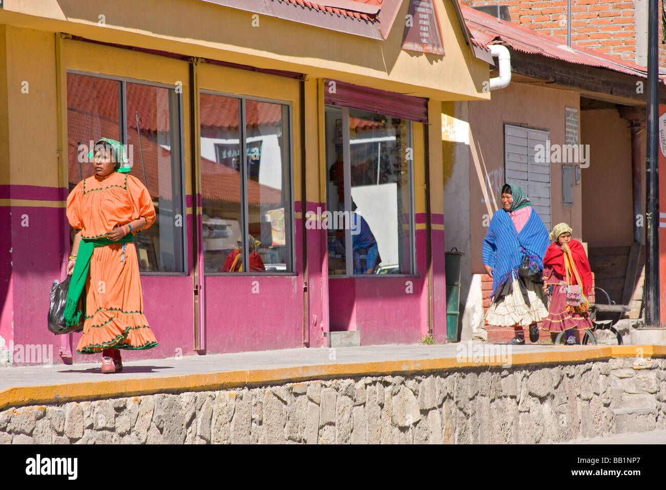 Tarahumara native Indian women walk the main street in Creel, a town in ...