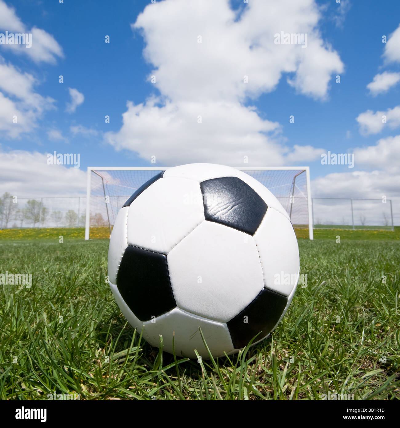 Low angle view of soccer ball agianst goal net and blue sky Stock Photo ...