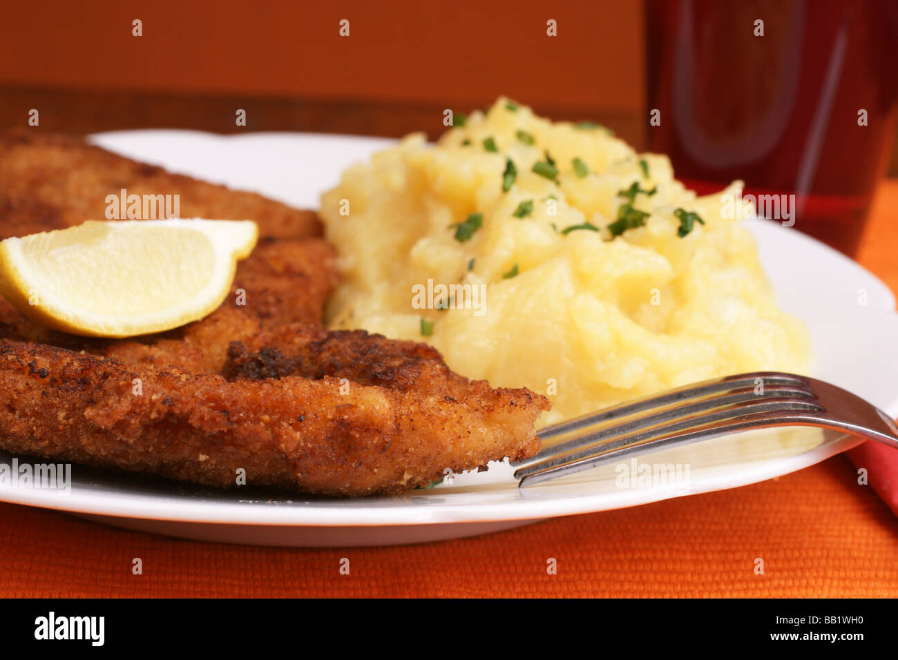Wiener Schnitzel with potato salad topped with chopped chives Stock ...
