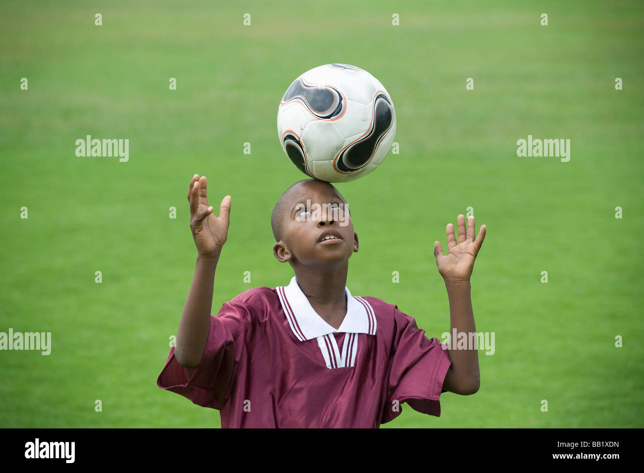 A young boy headers a soccer ball, Johannesburg, South Africa Stock ...