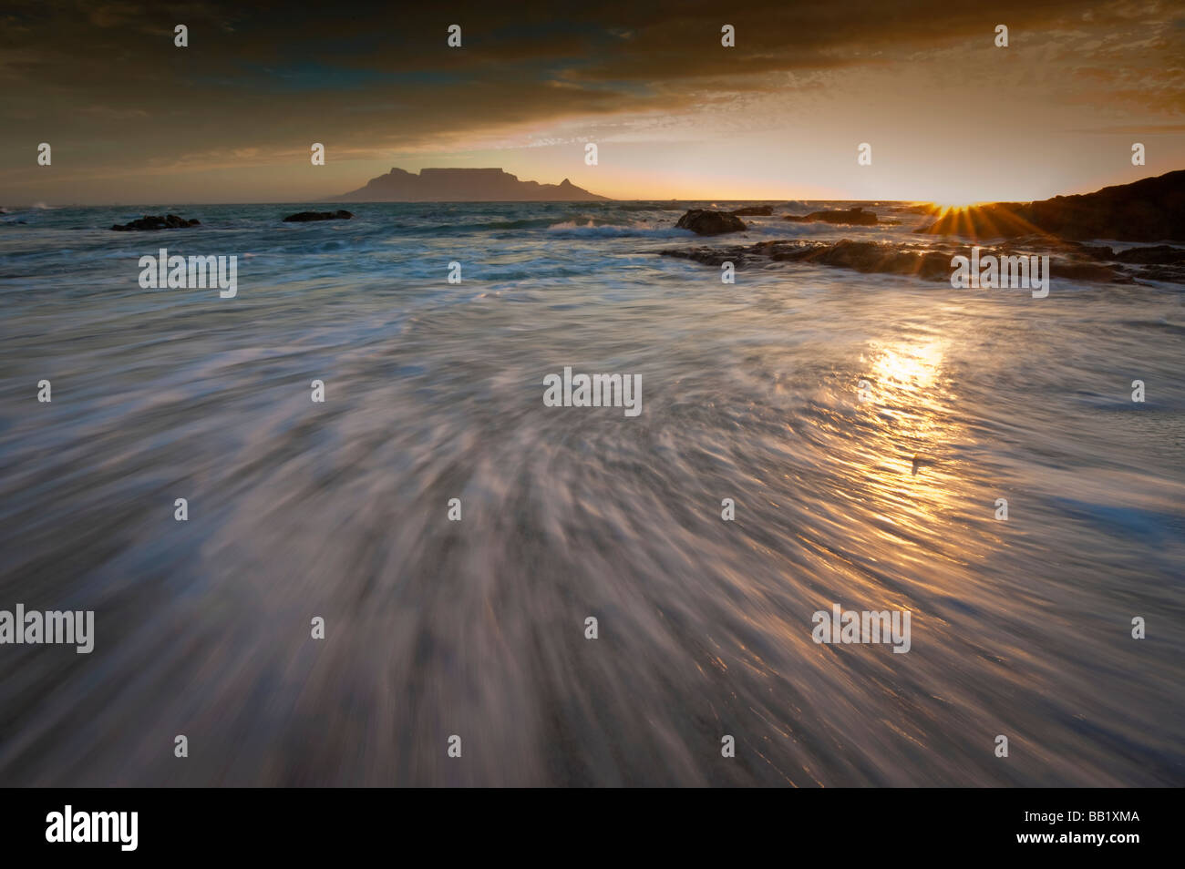 Table Mountain sunset with wave patterns, Bloubergstrand, Cape Town ...
