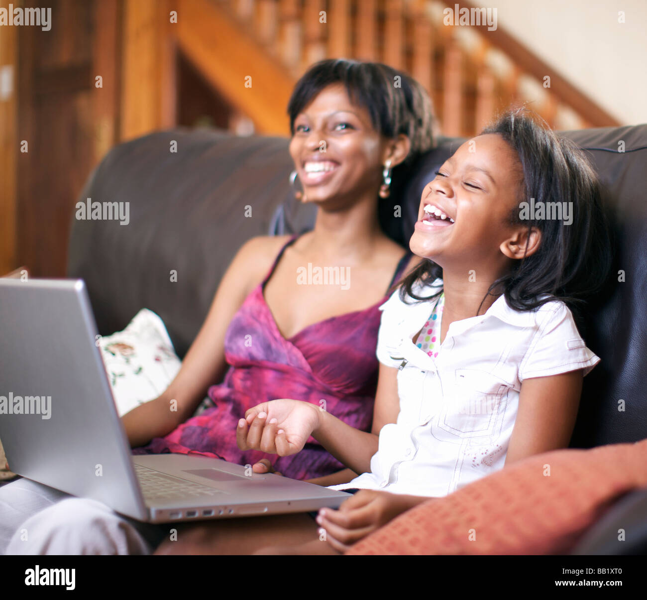 Mother and child laughing at laptop computer, Pietermaritzburg, KwaZulu ...