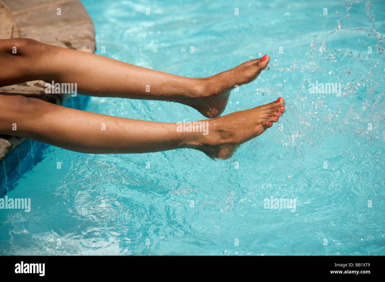Woman playing with feet in swimming pool, Pietermaritzburg, KwaZulu ...