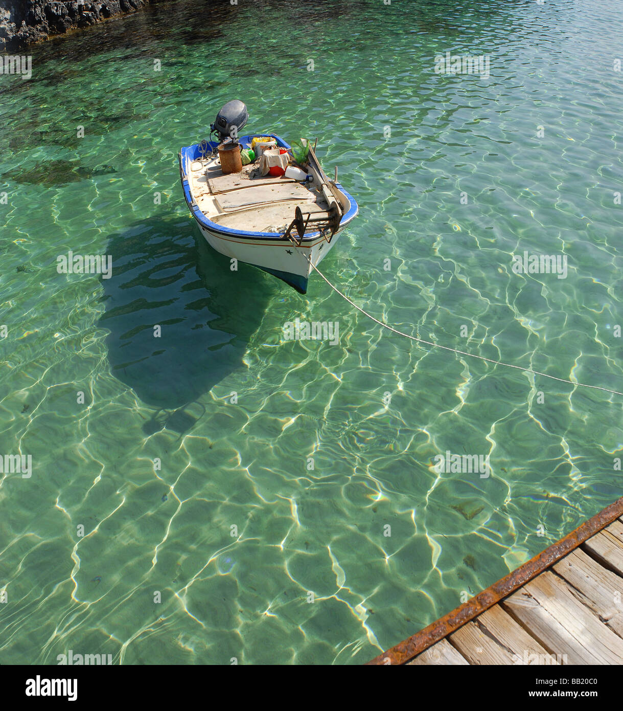 A fisherman boat docked in Lindos bay Island of Rhodes Greece Stock ...