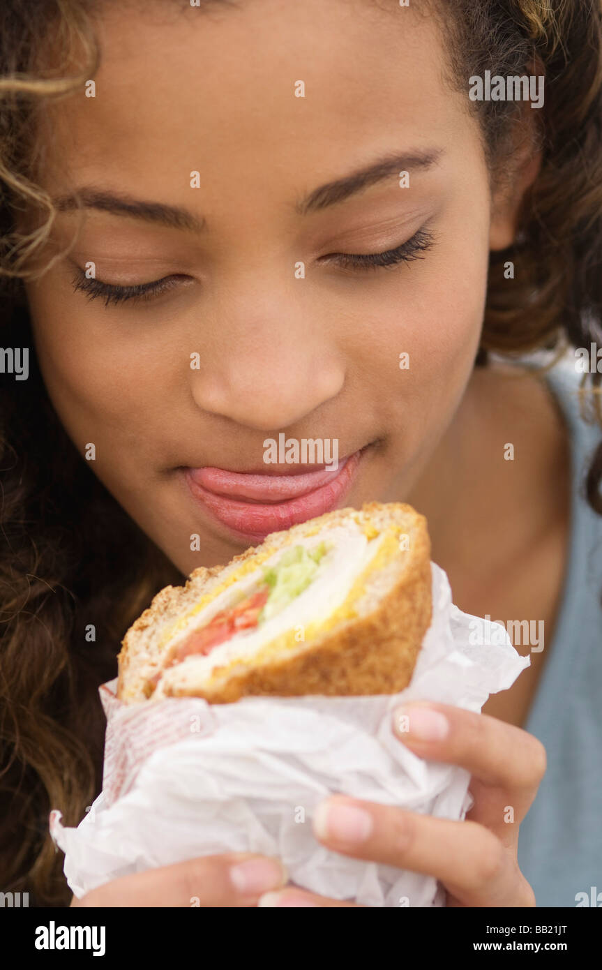 Close-up of a girl eating a sandwich Stock Photo - Alamy