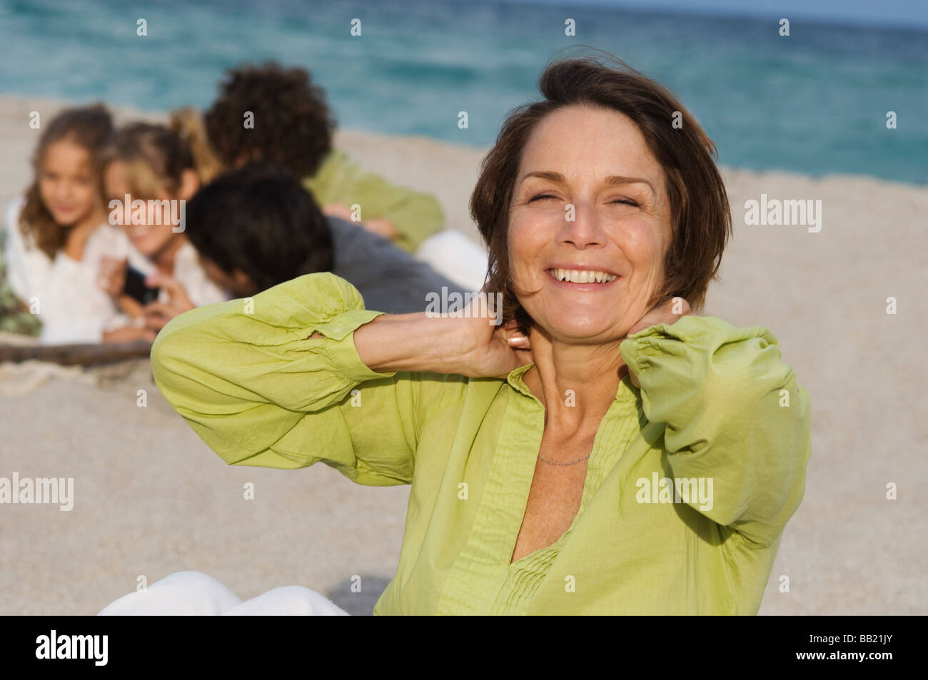 Woman smiling on the beach Stock Photo - Alamy