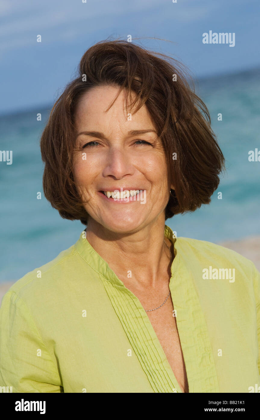 Woman smiling on the beach Stock Photo - Alamy