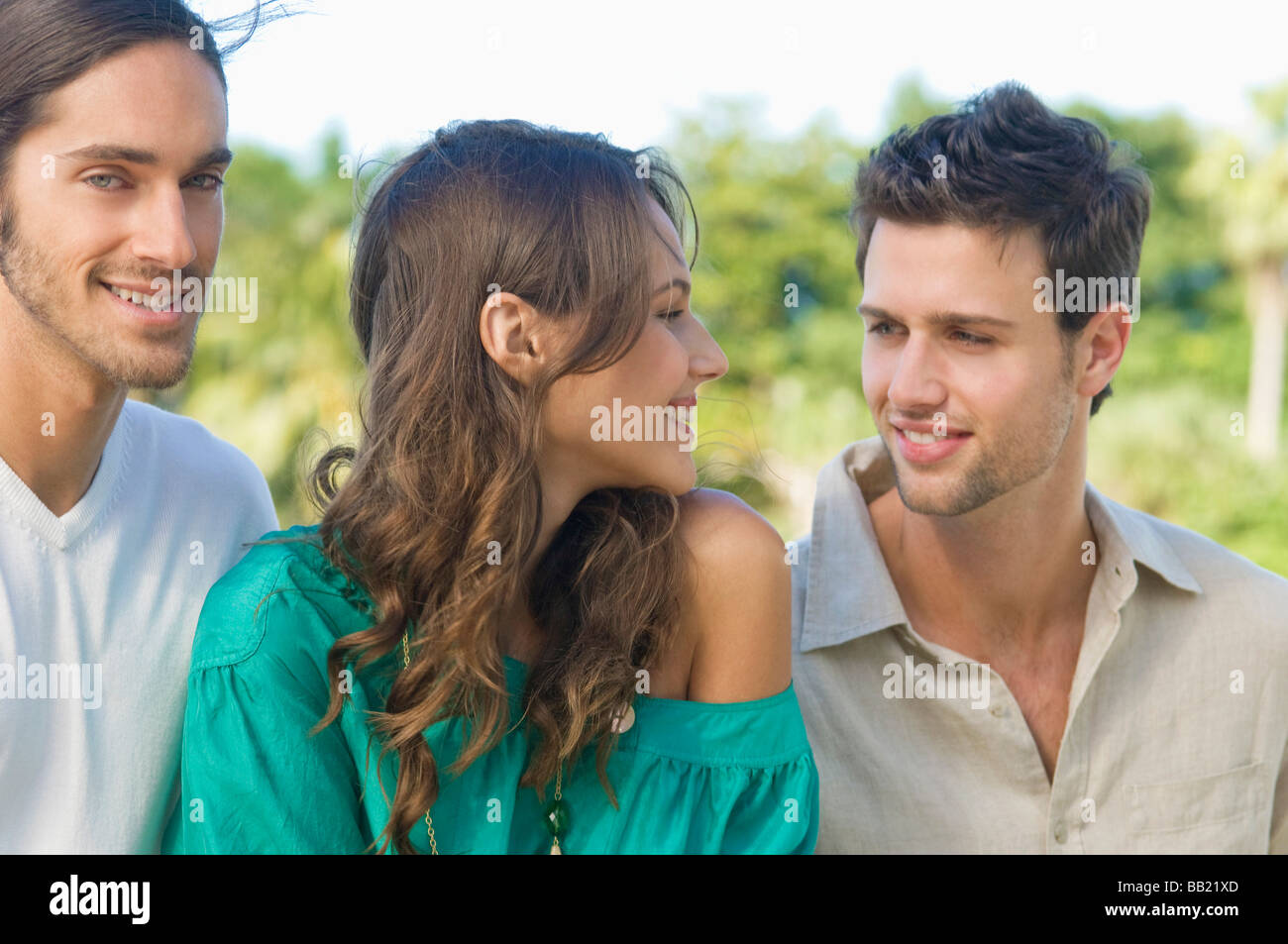 Three friends smiling Stock Photo - Alamy