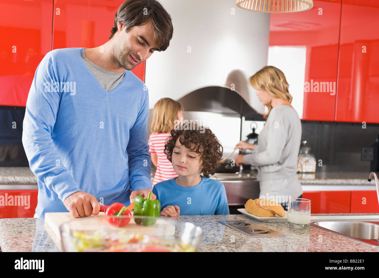 Family cooking food in the kitchen Stock Photo - Alamy