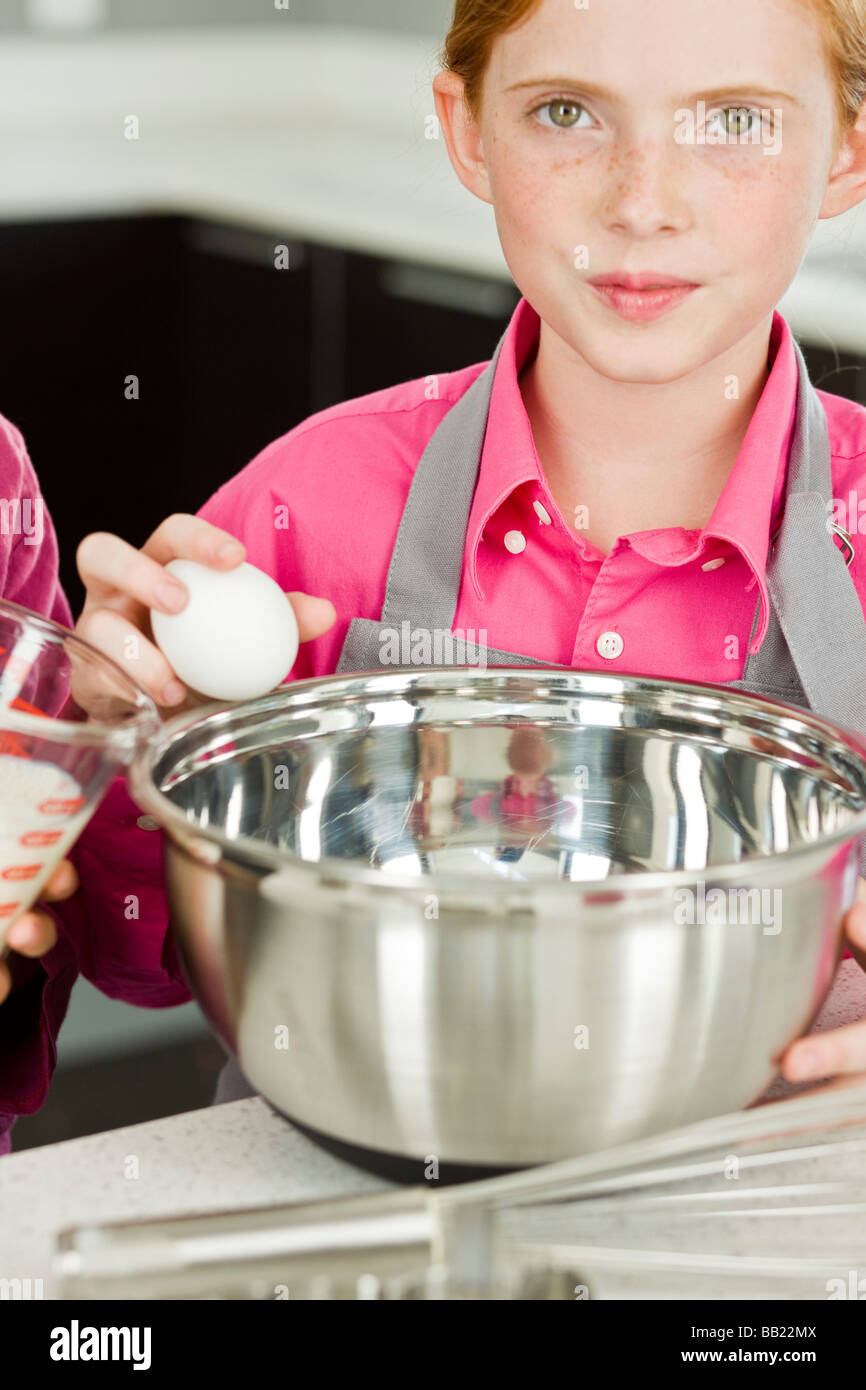 Portrait of a girl cooking food in the kitchen Stock Photo - Alamy