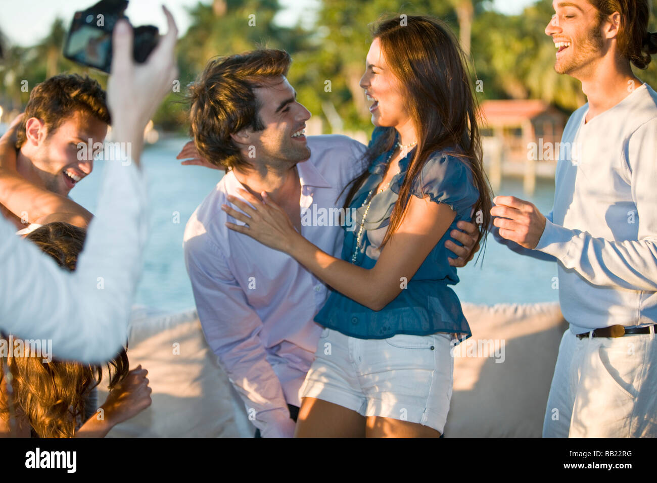 Group of friends enjoying at a tourist resort Stock Photo - Alamy
