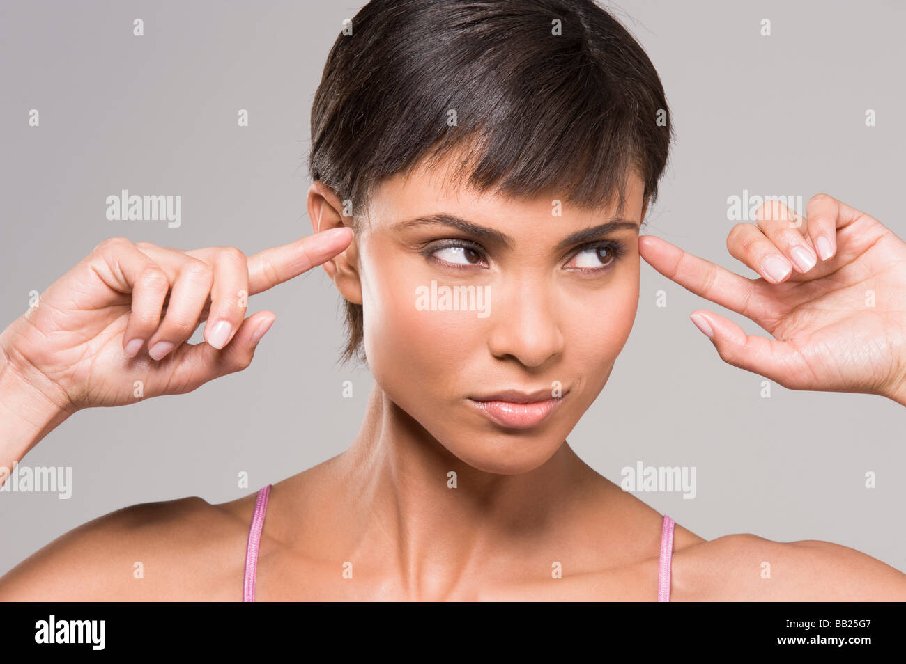 Woman rubbing her temples Stock Photo - Alamy