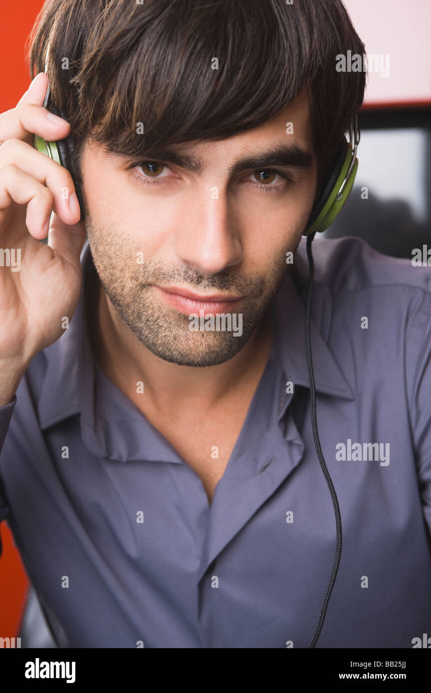Portrait of a man listening to headphones Stock Photo - Alamy