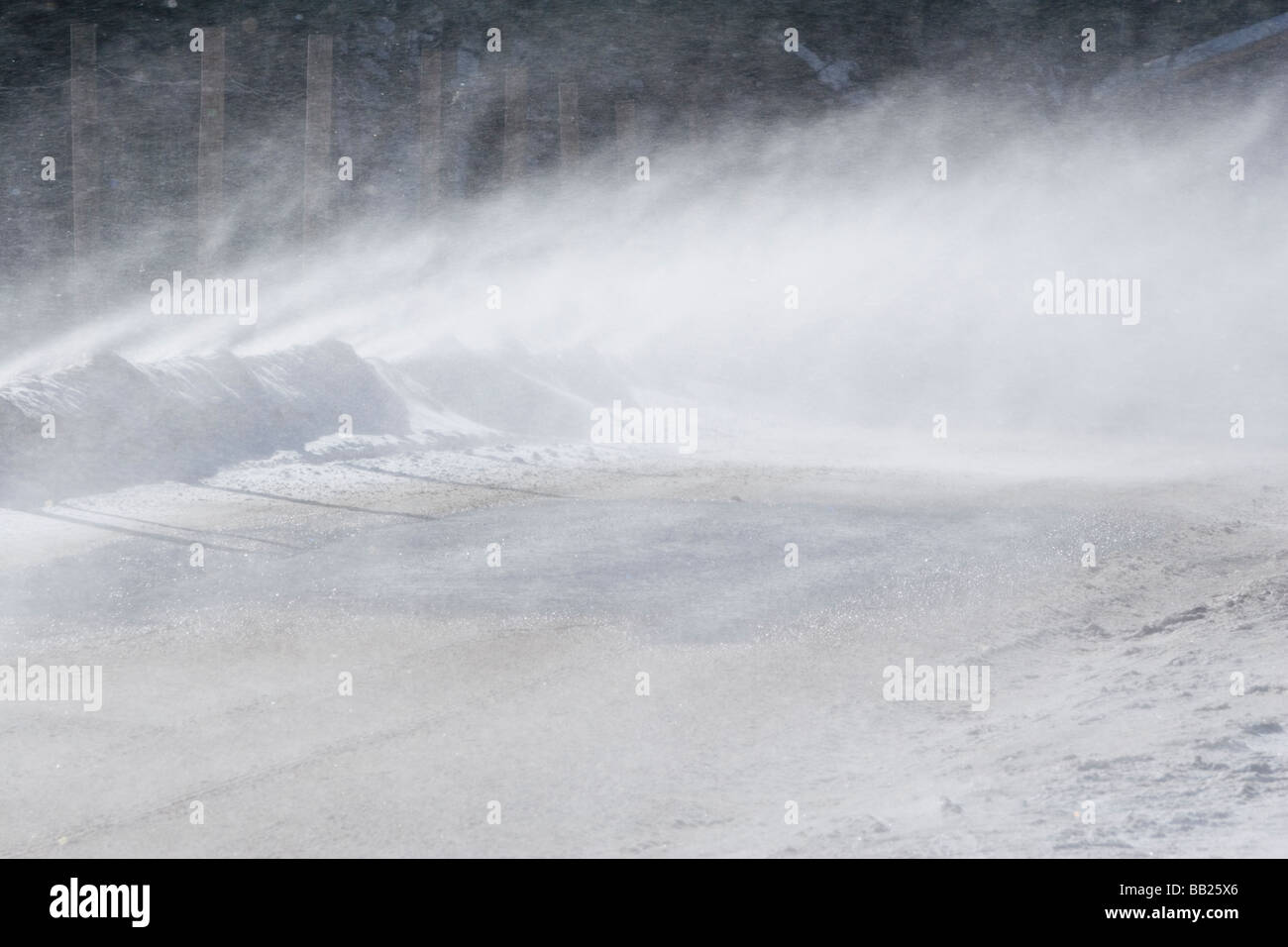 drifting snow across mountain road Stock Photo - Alamy