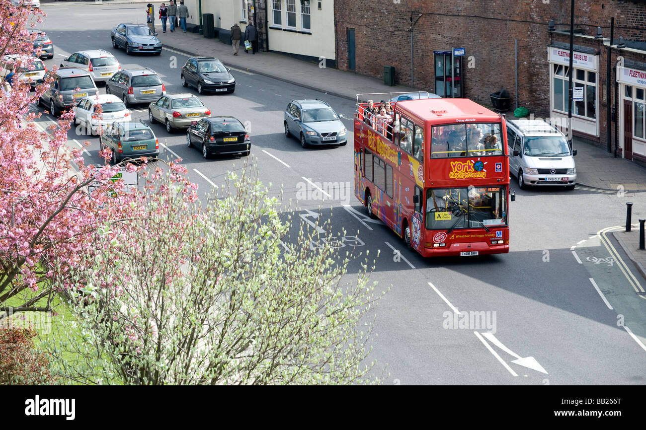 Tourists on an open top sightseeing double decker bus driving through ...