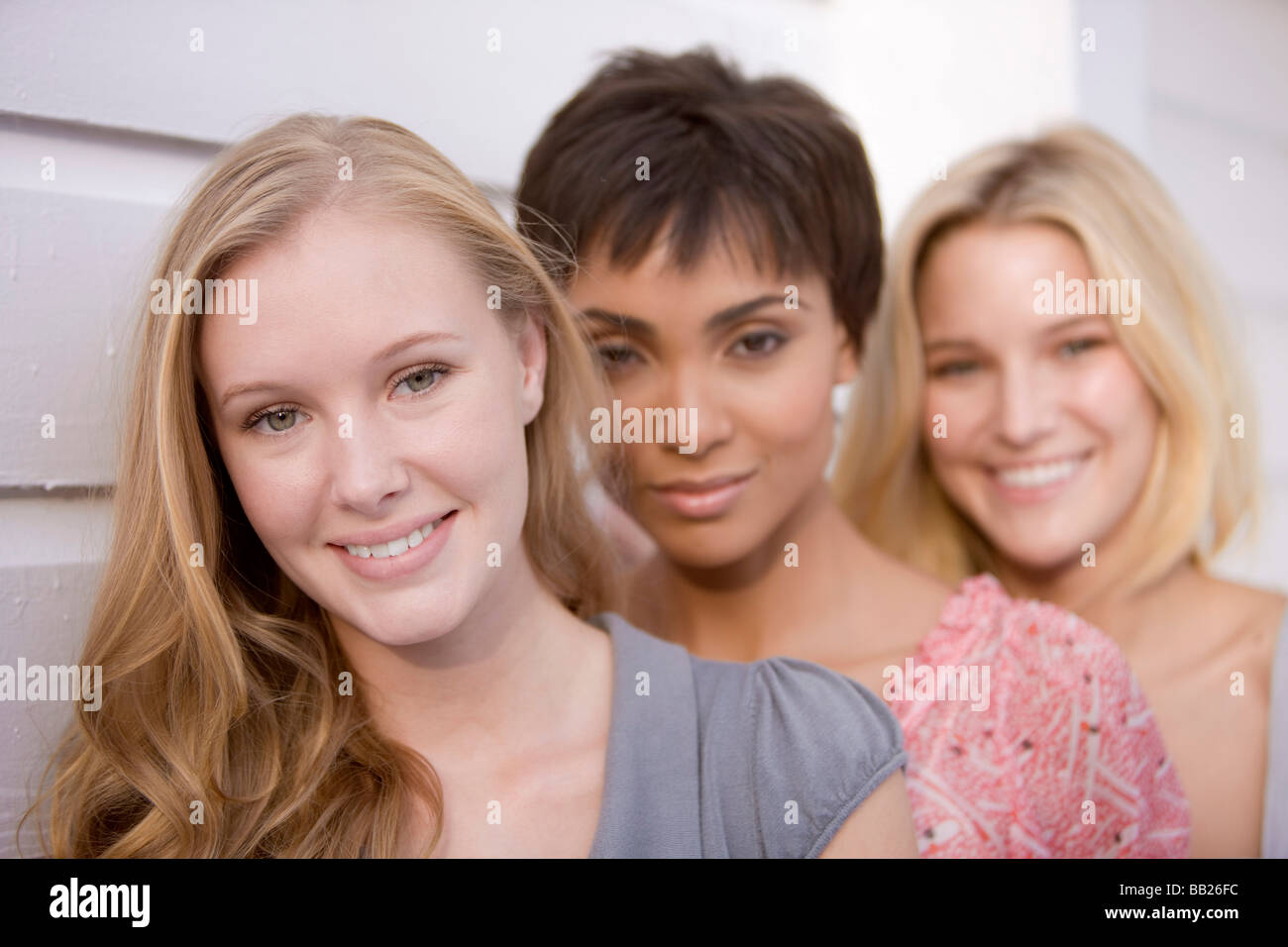 Portrait of three women smiling Stock Photo - Alamy