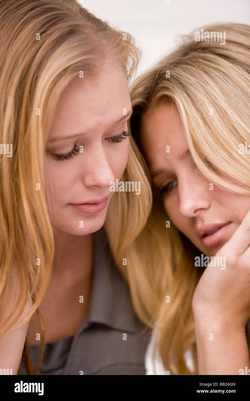 Two young women consoling friend hi-res stock photography and images ...