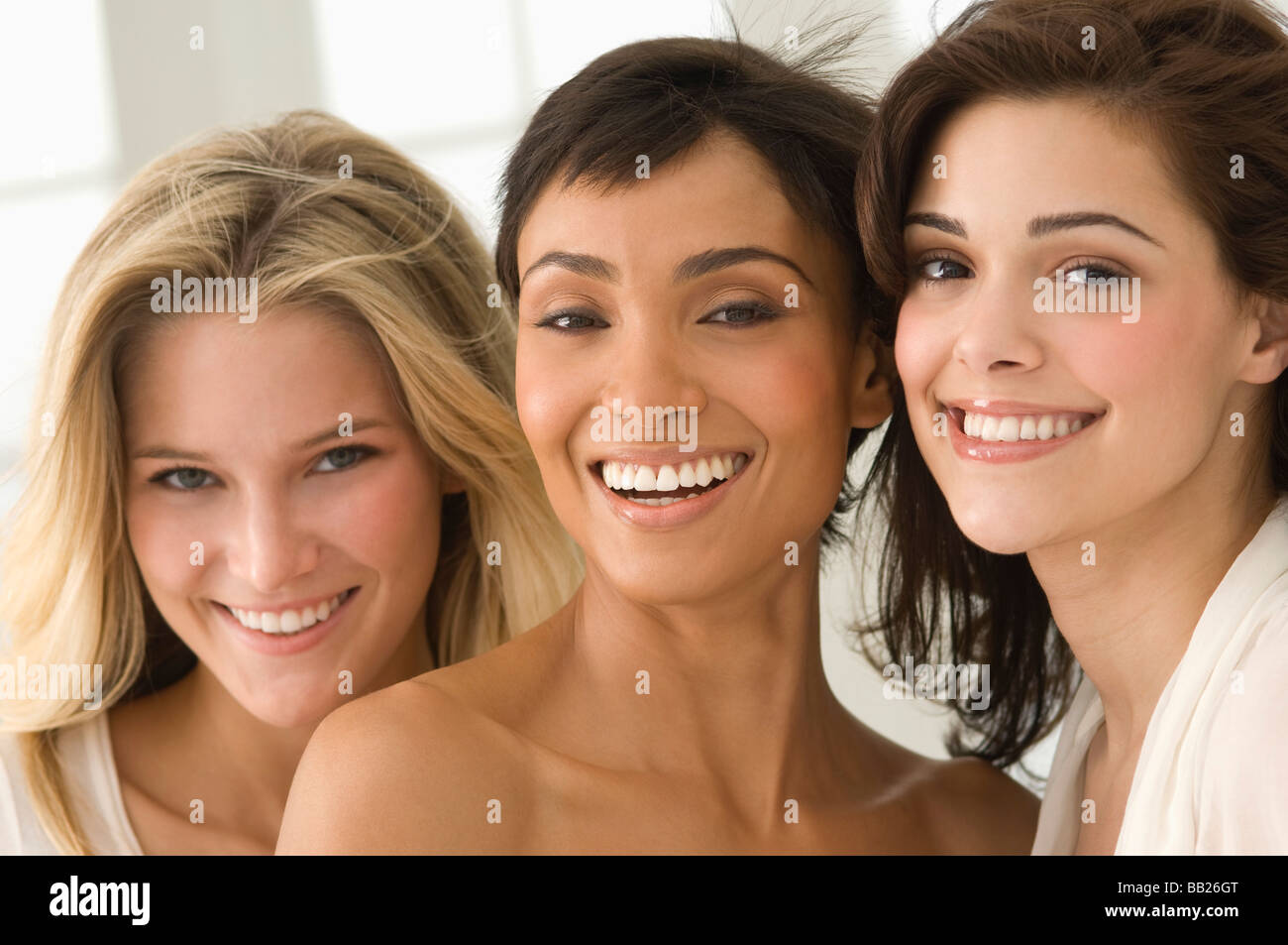 Portrait of three female friends smiling Stock Photo - Alamy
