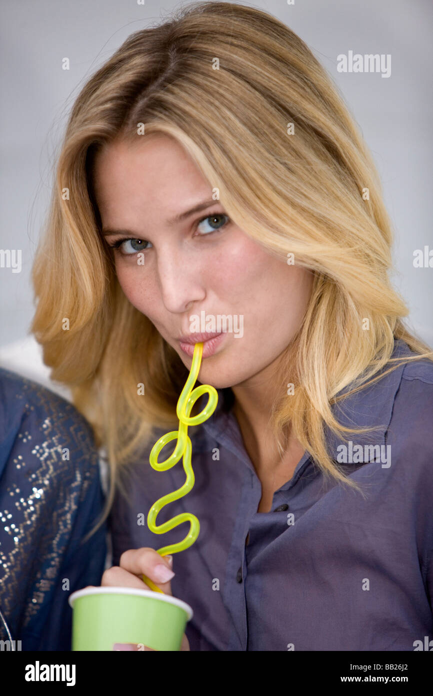 Portrait of a woman drinking from a disposable cup Stock Photo - Alamy